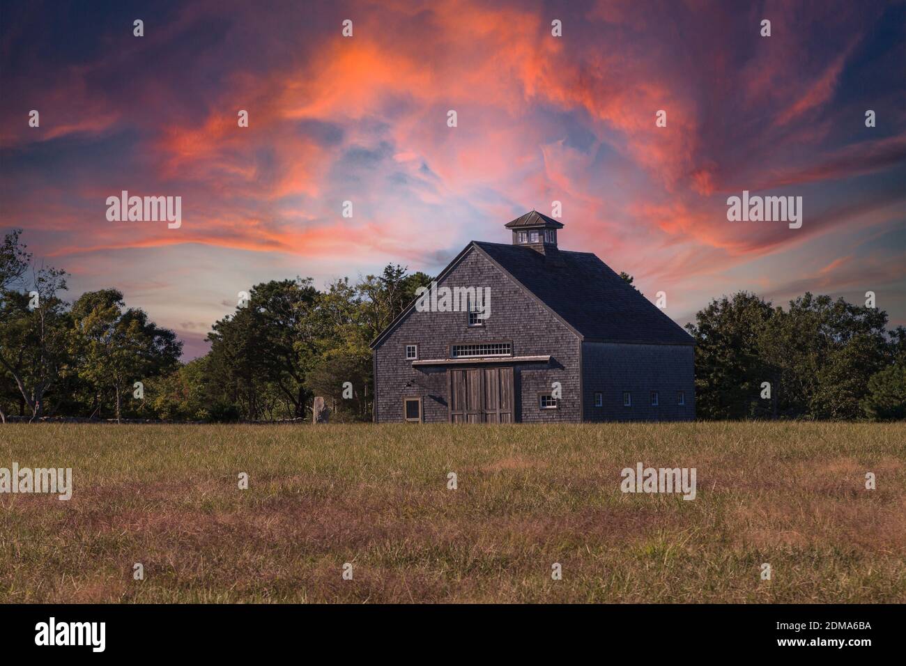 Sunset over a rustic barn in a field on Cape Cod, Massachusetts Stock ...