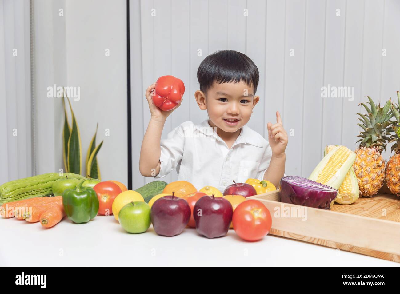 Cute Boy With Fresh Food At Home Stock Photo - Alamy