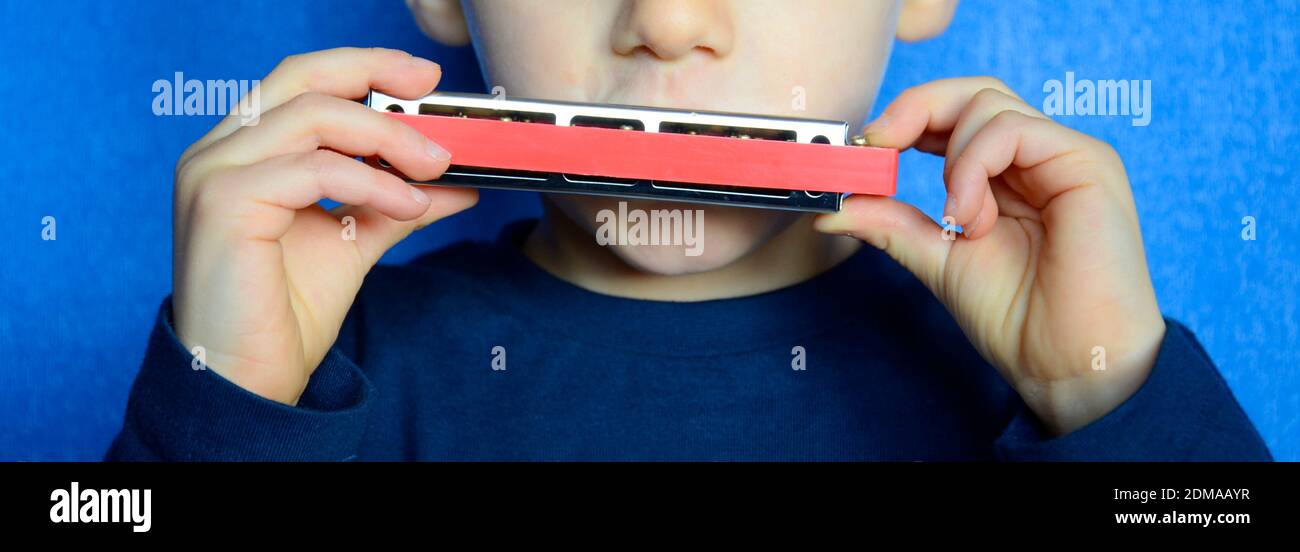 Boy playing harmonica hi-res stock photography and images - Alamy