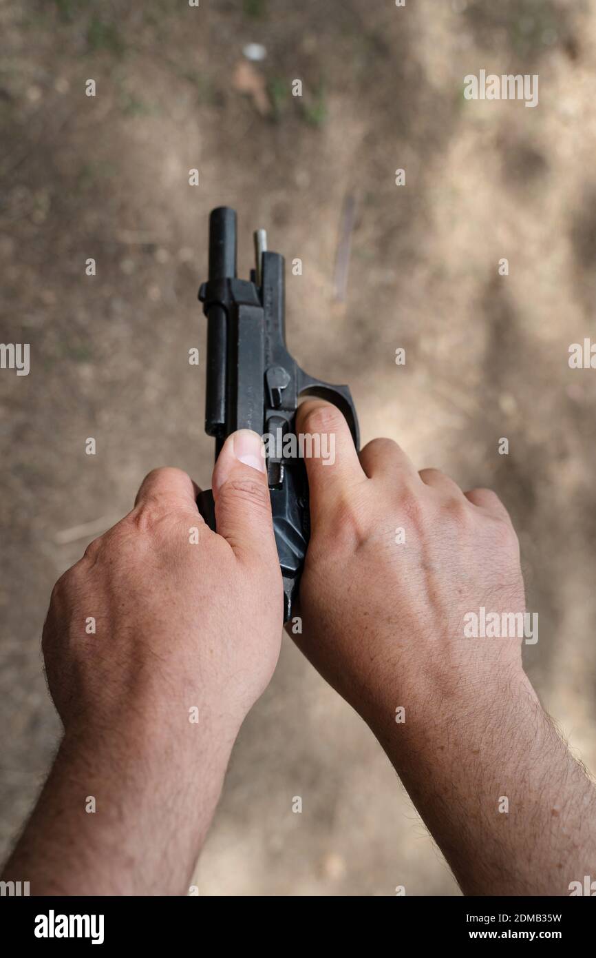 Man reloads the gun hi-res stock photography and images - Alamy
