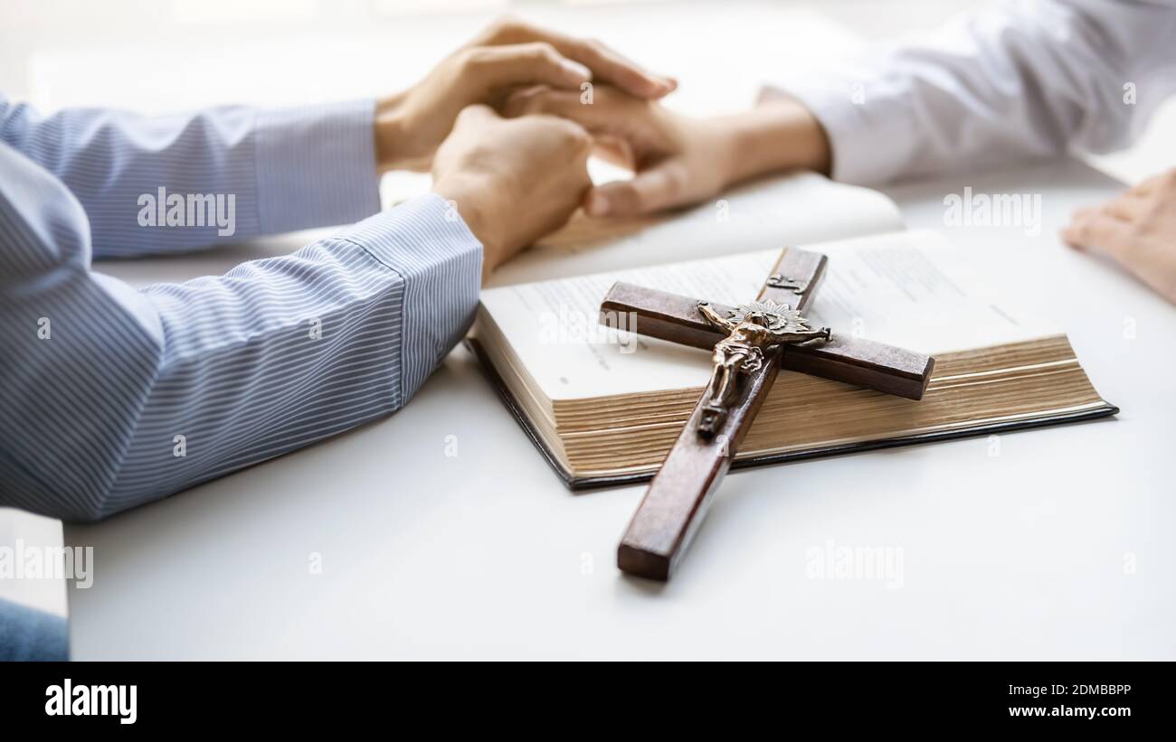 Bible Praying Hands Holding Cross High Resolution Stock Photography and ...