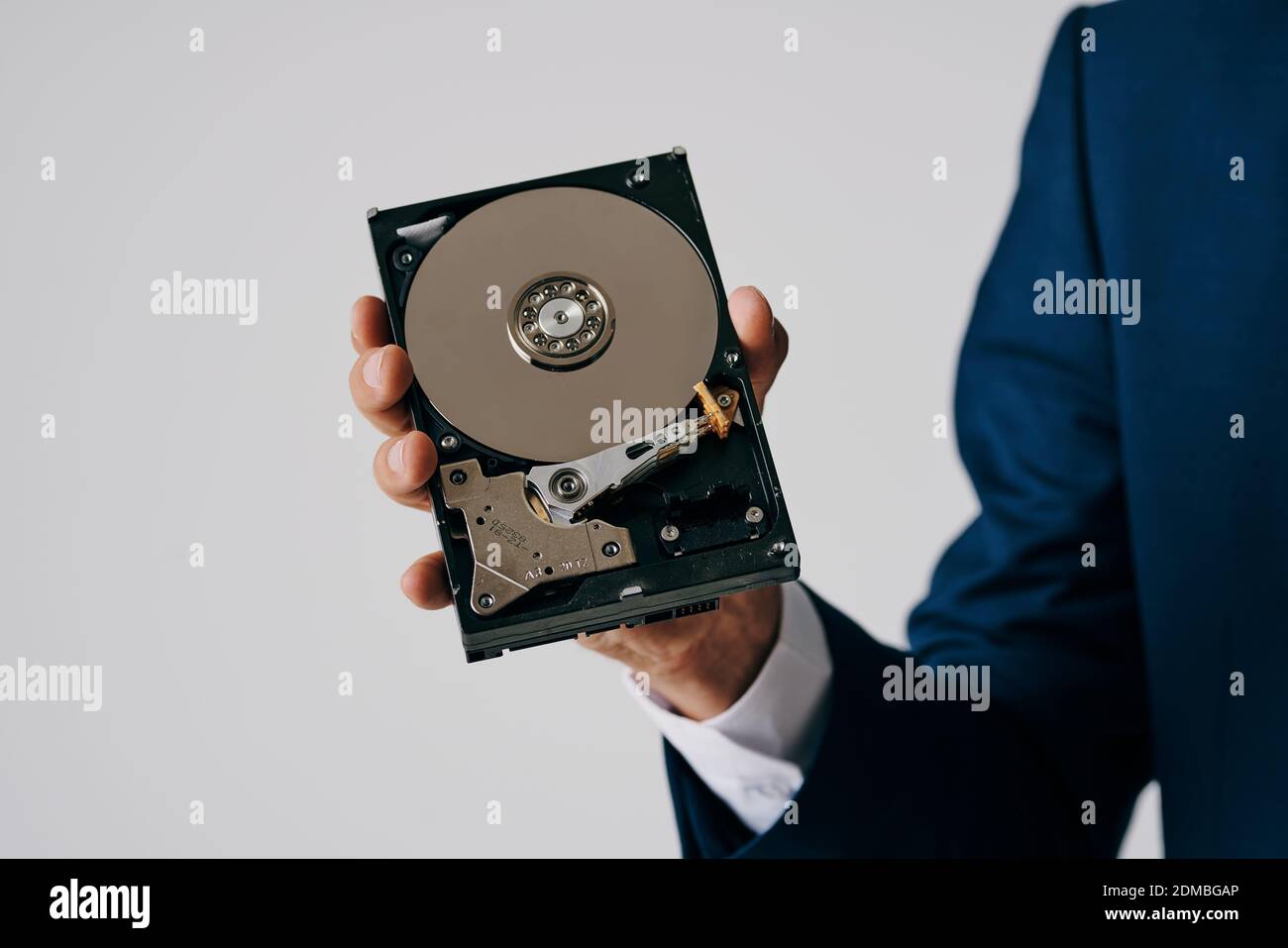 business man holding disassembled hard drive on gray background Stock ...