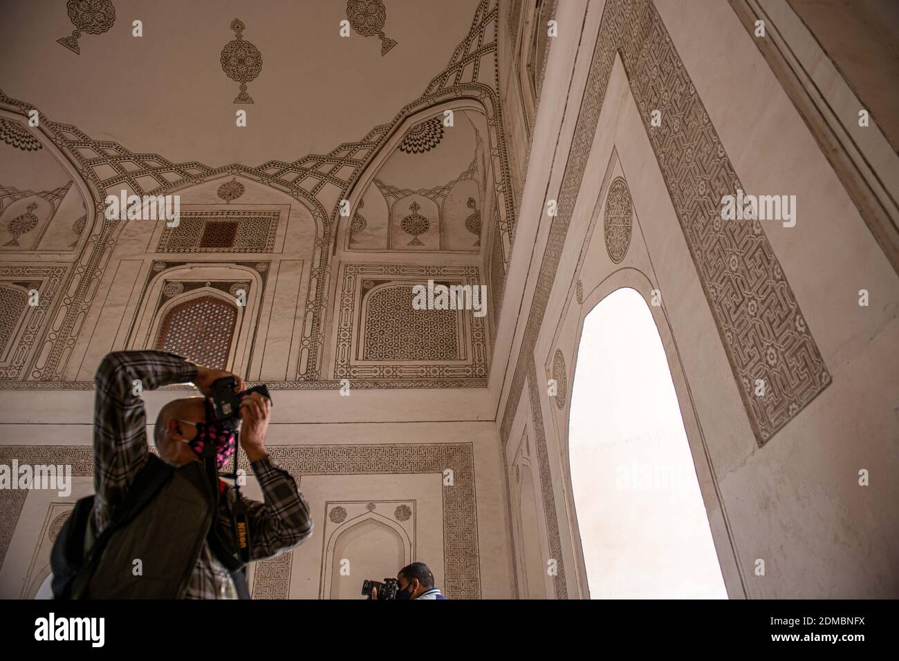 A photojournalist taking pictures inside the tomb during the event ...