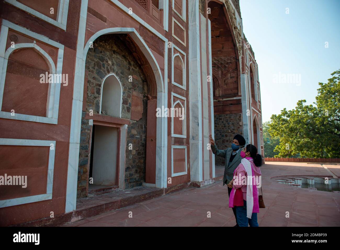 Media personnel looking at the newly renovated tomb during the event ...