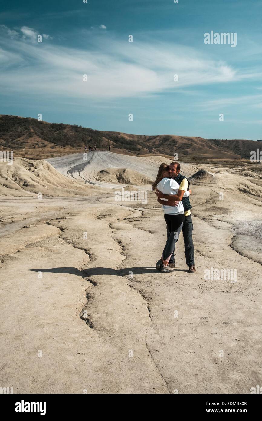 Young couple wearing sportswear and hugging outdoors, picture taken in ...