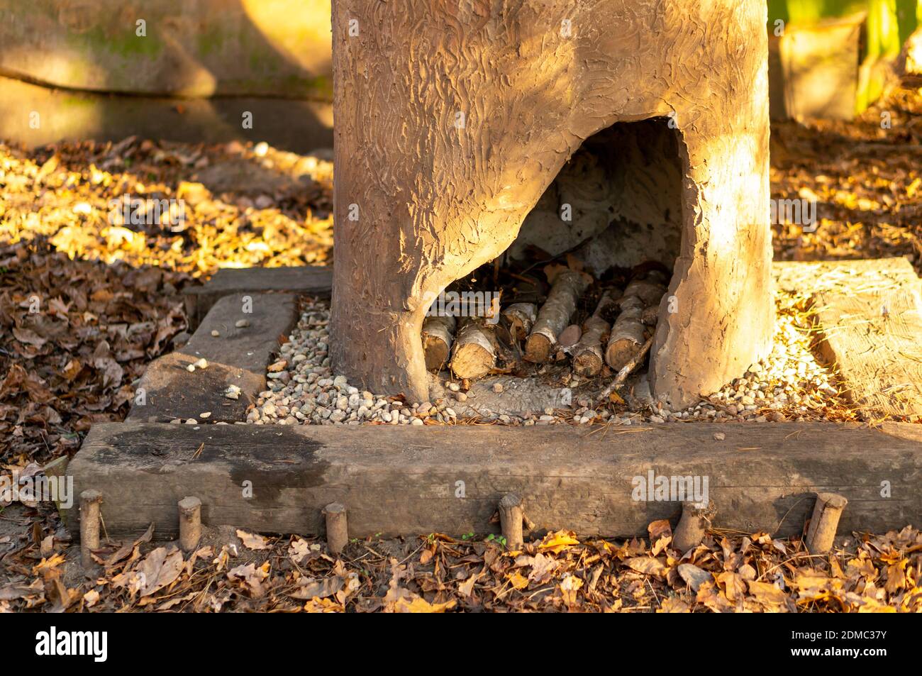 The logs of wood in an outdoor barbeque shaped like a tree trunk Stock ...