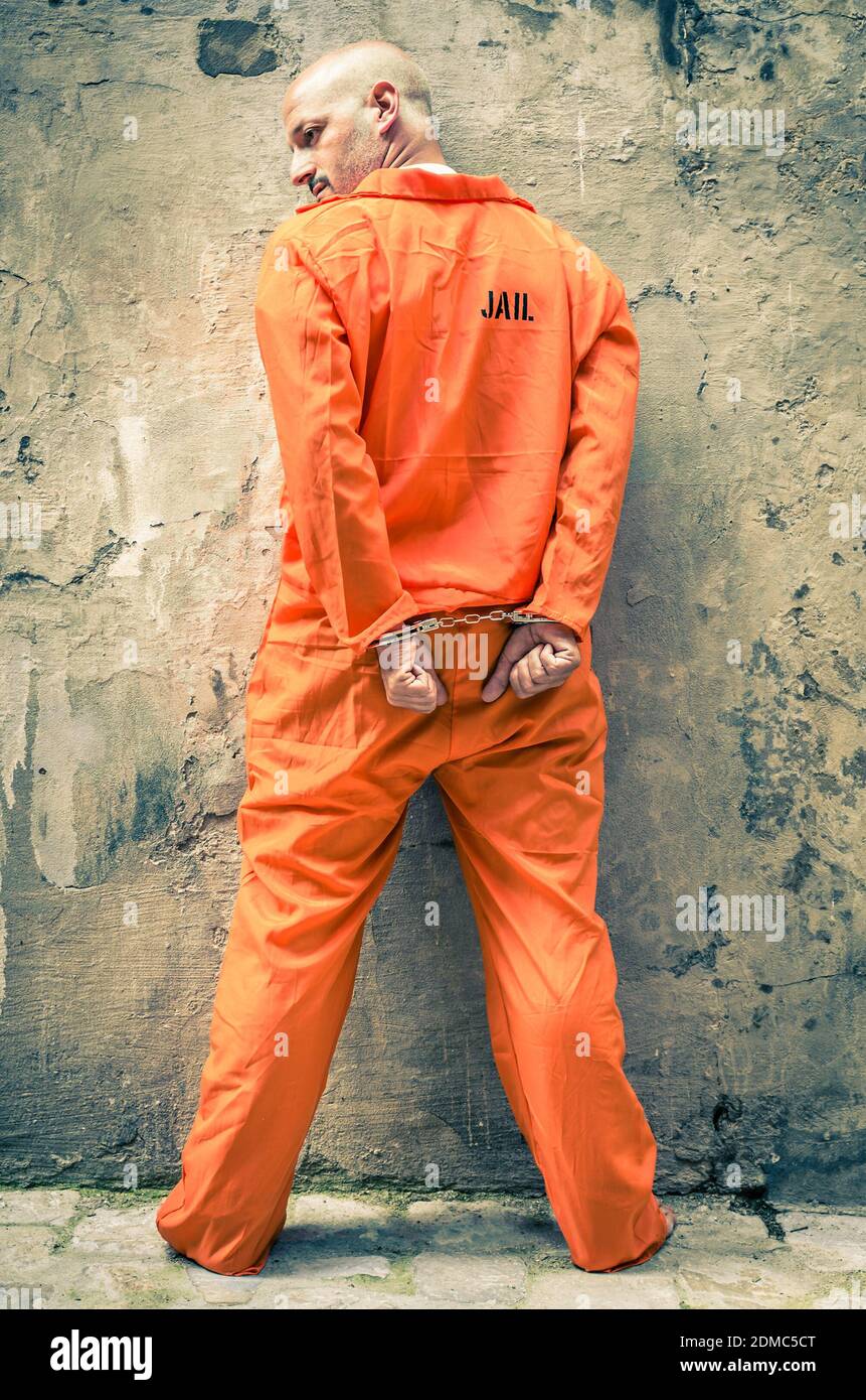 Handcuffed behind back prison hi-res stock photography and images - Alamy