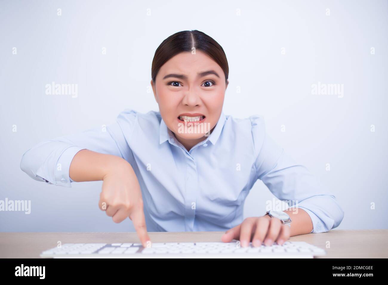 Crazy woman with hands on keyboard Stock Photo - Alamy
