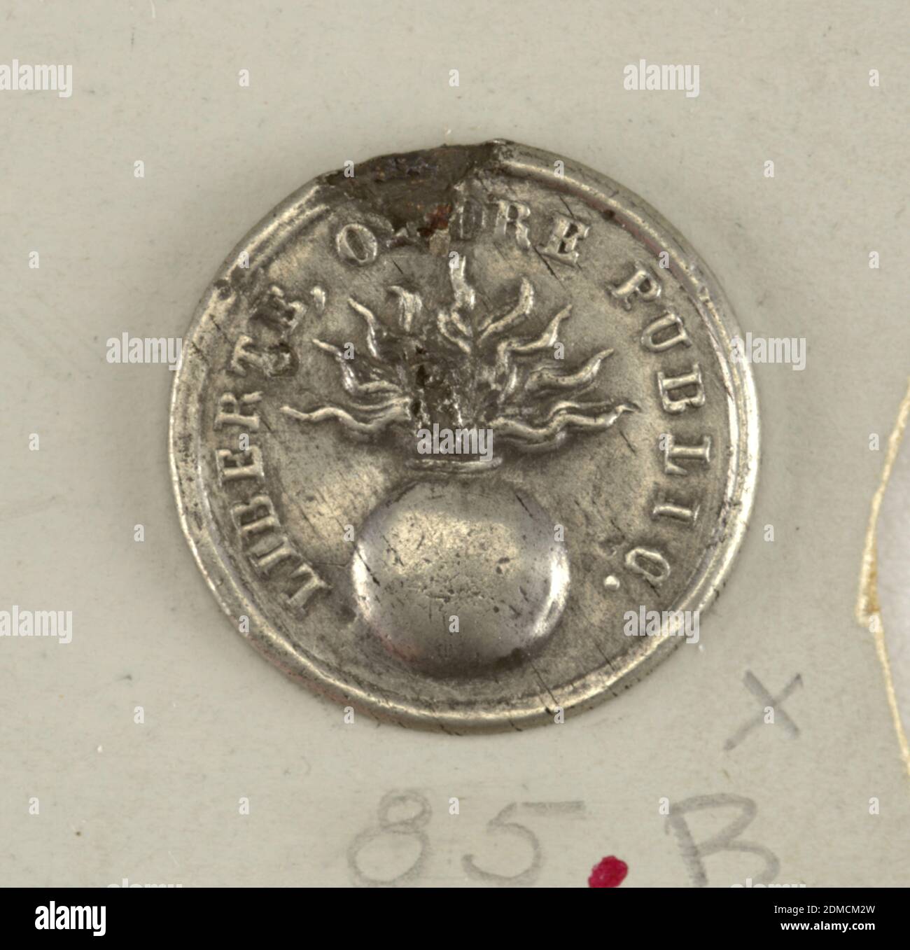 Buttons, Pewter and brass, Button with raised design of a flaming bomb ...