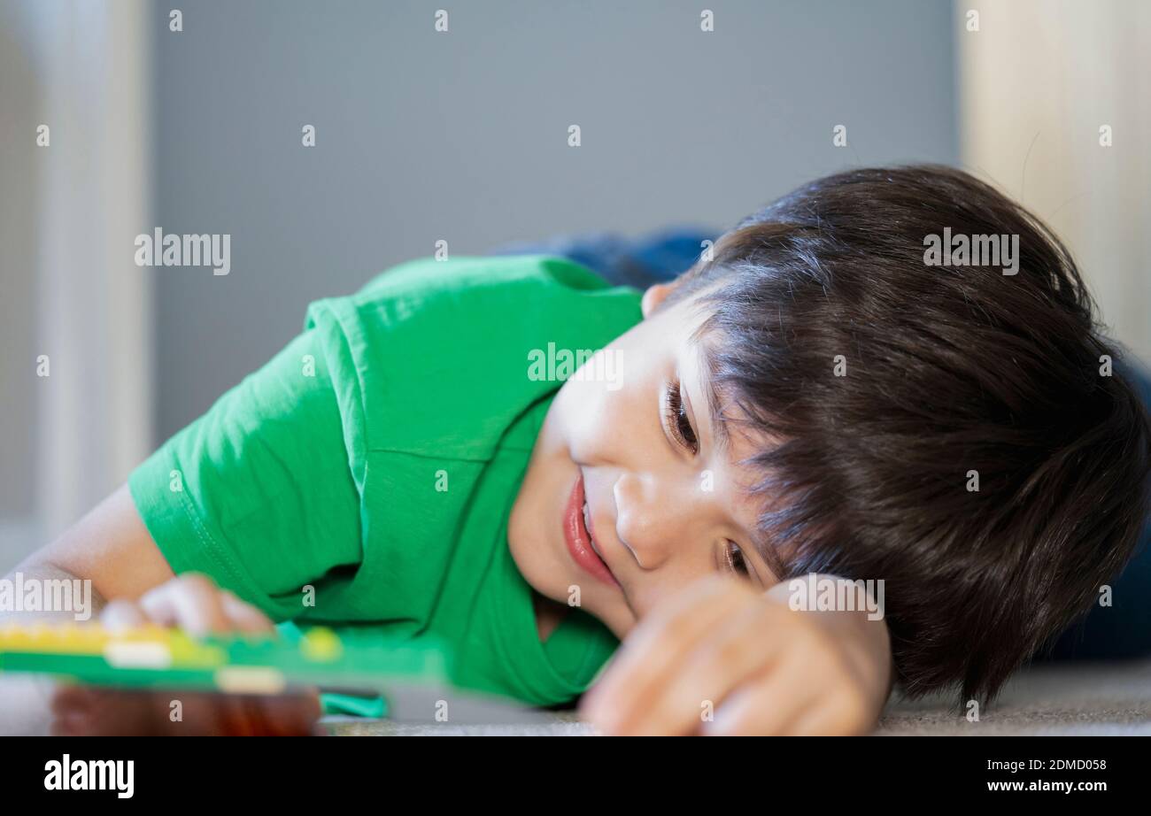 Toddler boy laying on floor playing hi-res stock photography and images ...