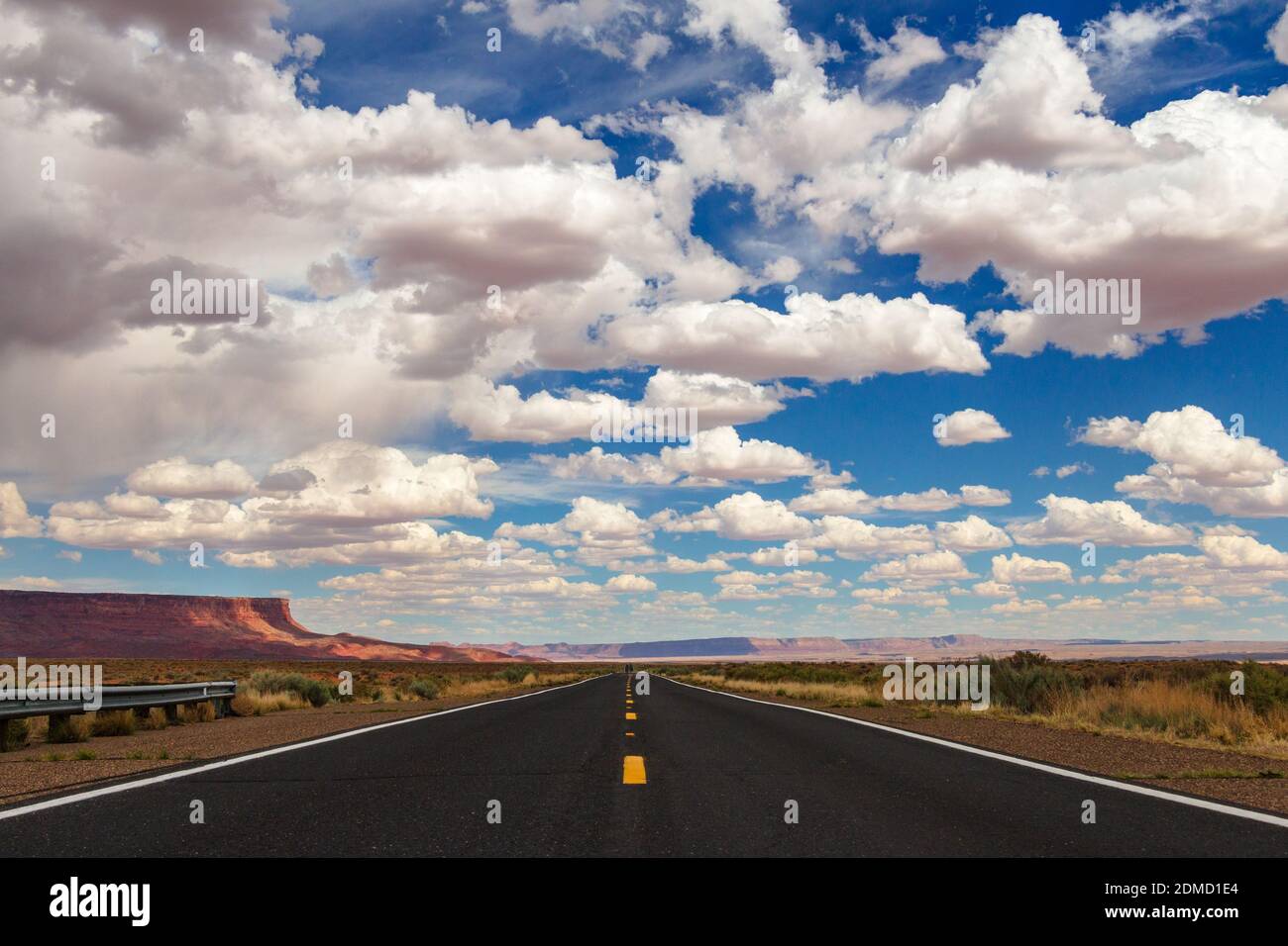 Empty road in the Arizona desert with big clouds and blue sky Stock ...