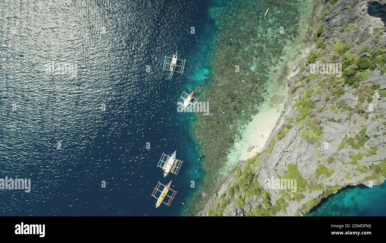 Top down of traditional boats at rock ocean coast aerial view. Majestic ...