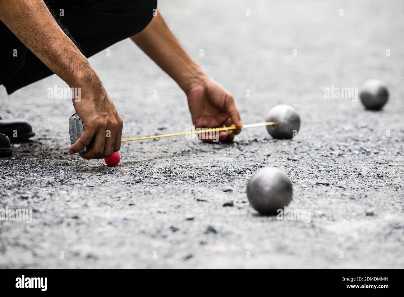 Man measuring the distance of petanque ball in petanque field Stock ...