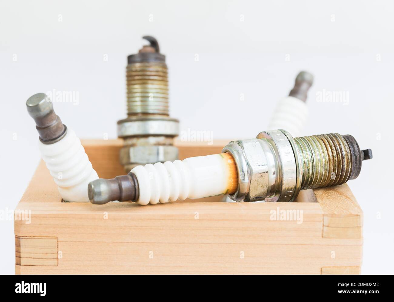 Close up old burned spark plug in wood box on white background Stock ...