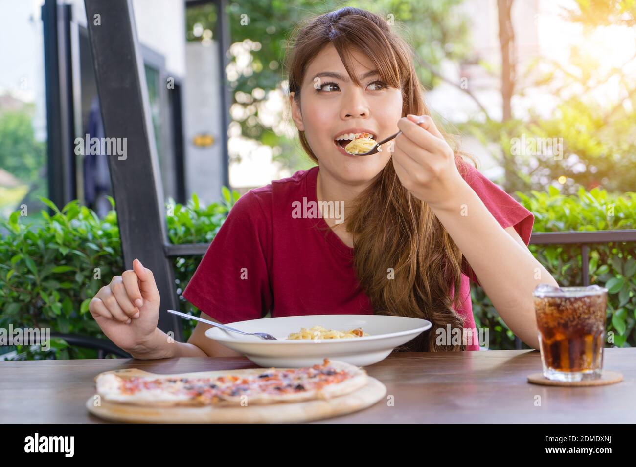 Woman eating pizza alone in restaurant hi-res stock photography and ...