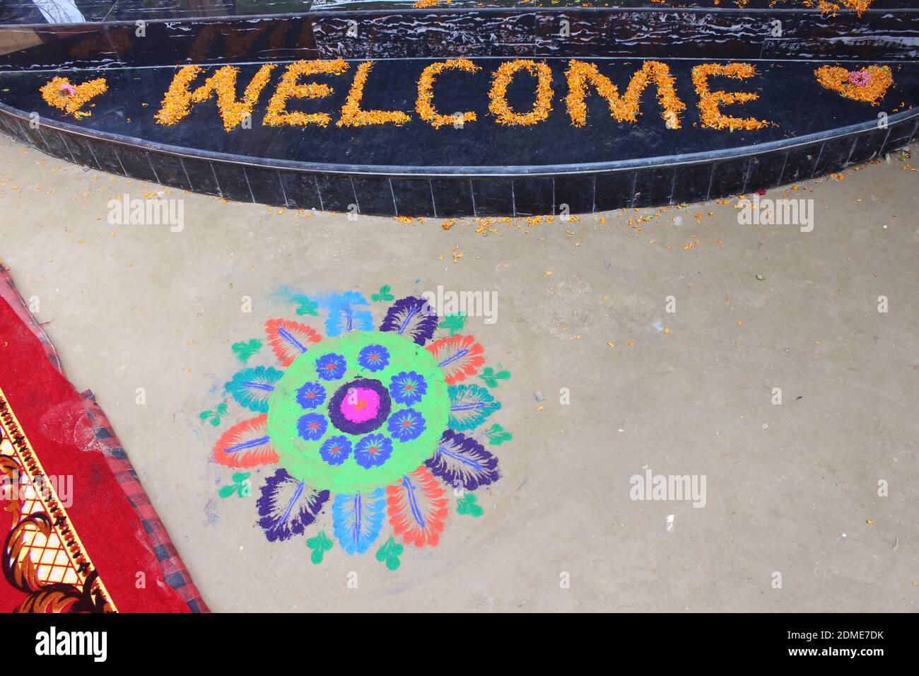 The entrance of a house decorated with floral patterns and a Welcome ...