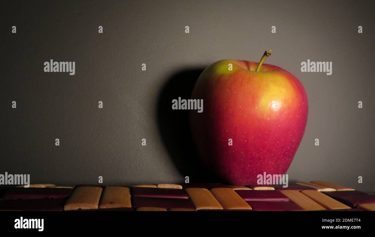 Red Apple On A Light Background With The Reflected Shadow Stock Photo ...