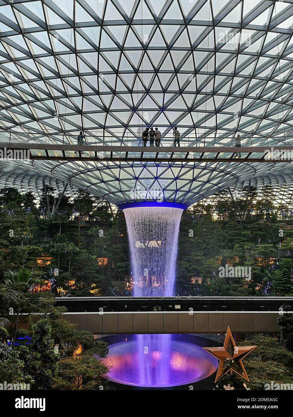 A vertical shot of the rain vortex at Singapore airport surrounded by ...