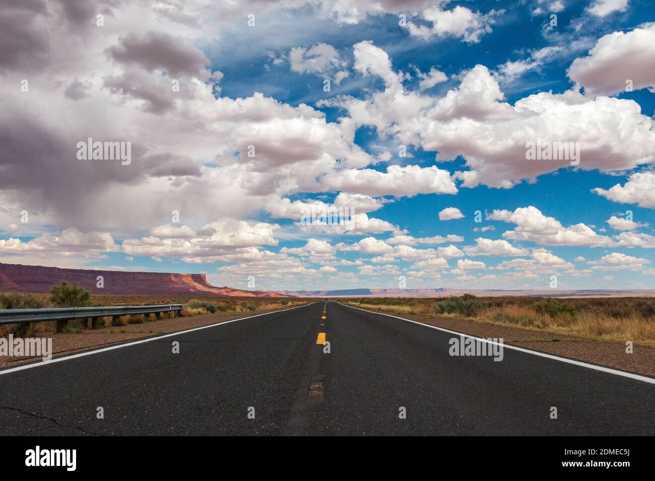 Empty road in the Arizona desert with big clouds and blue sky Stock ...