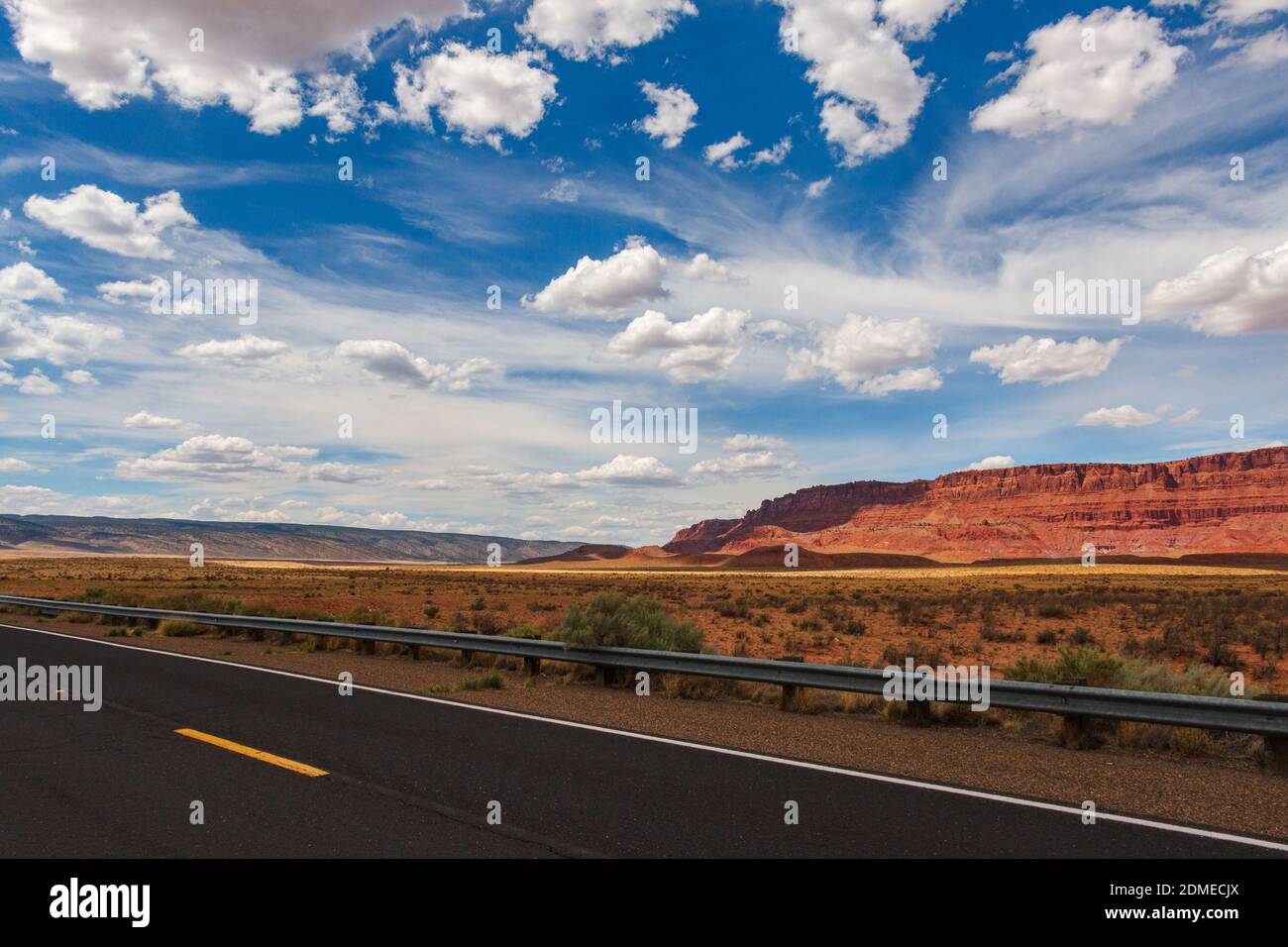 Empty road in the Arizona desert with big clouds and blue sky Stock ...