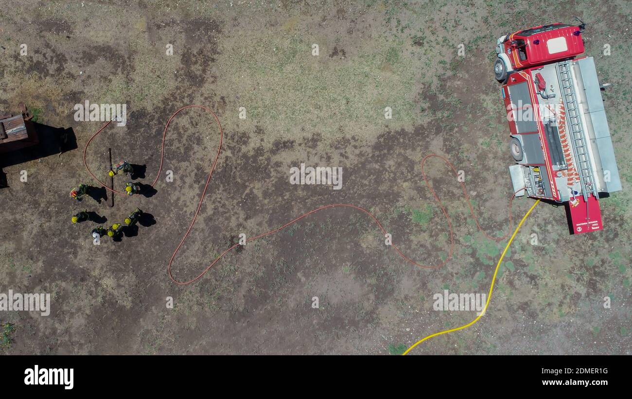 An aerial top view of firefighters meeting and a fire truck Stock Photo ...