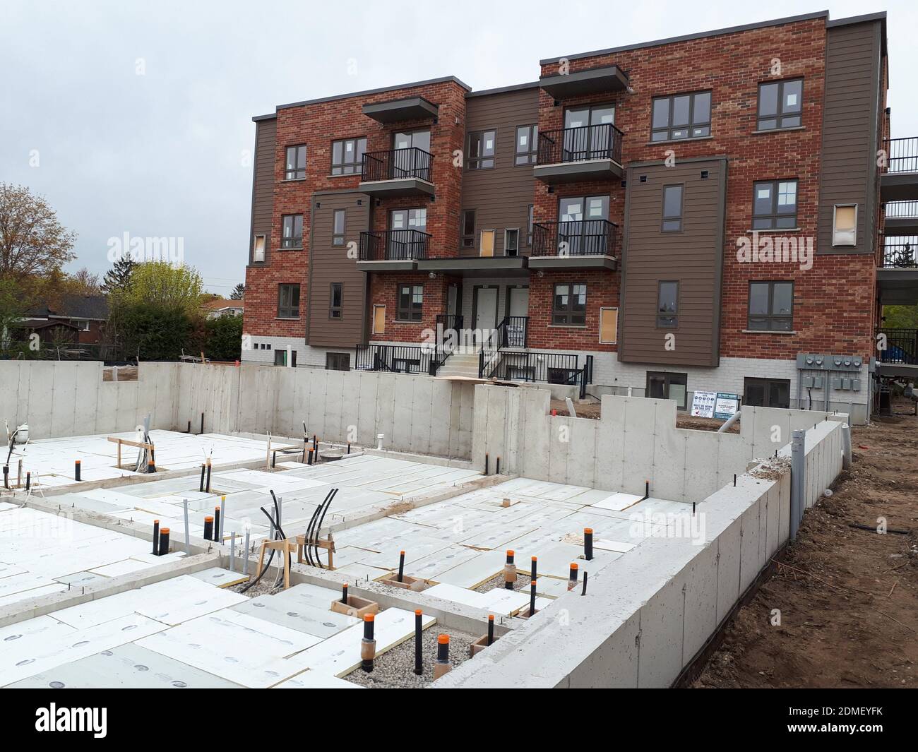 A modern residential building with a new building construction site in ...