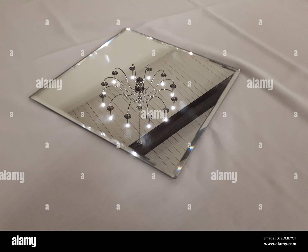 A beautiful illuminated ceiling chandelier reflection on a mirror Stock ...