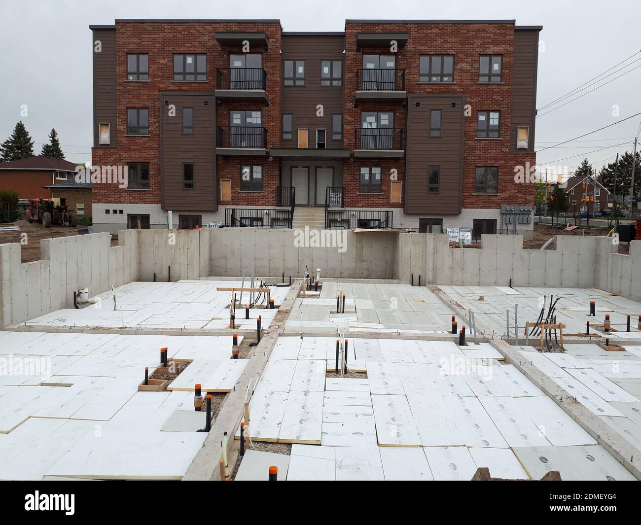 A modern residential building with a new building construction site in ...