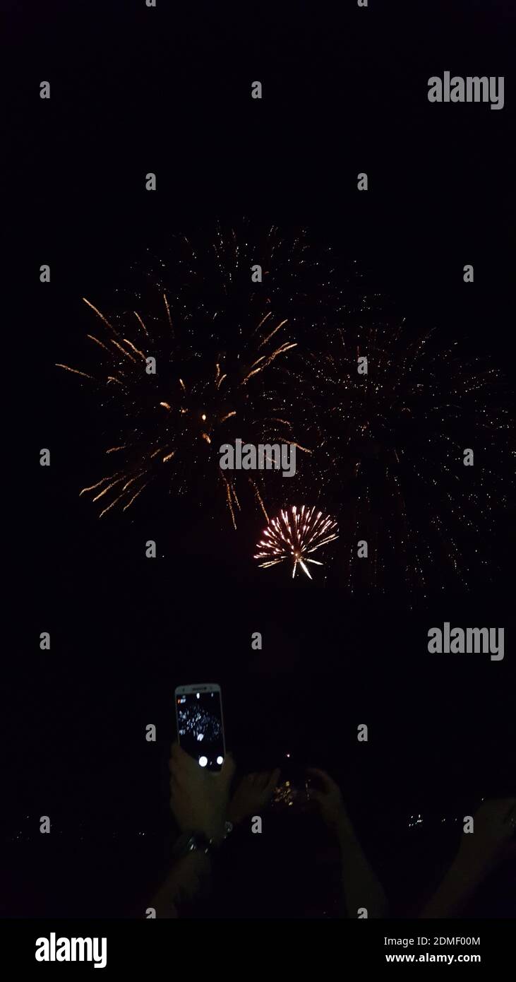 A vertical shot of a phone capturing a shining night sky with a ...