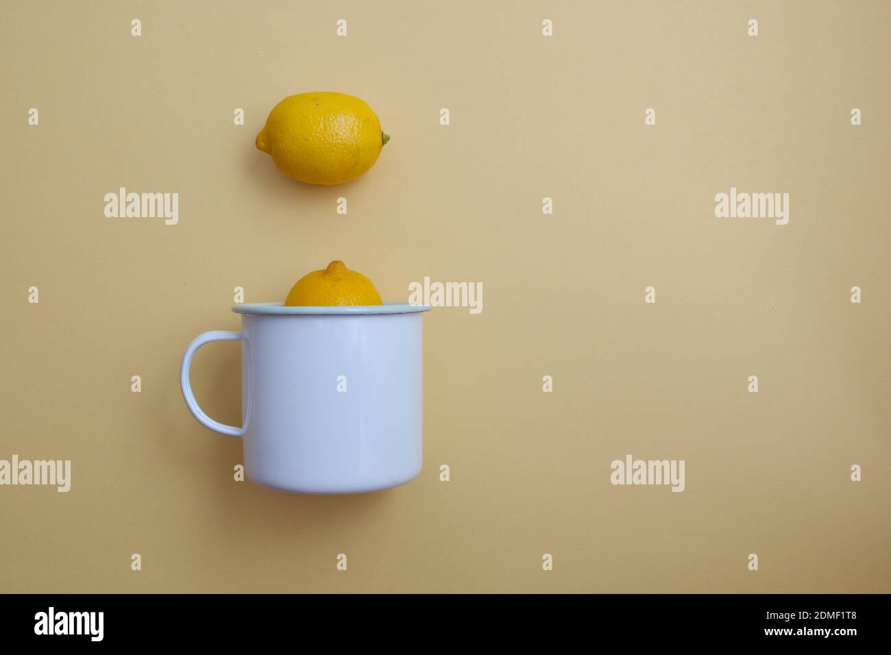 White Enamel Container And Lemon Against The Yellow Background Stock ...