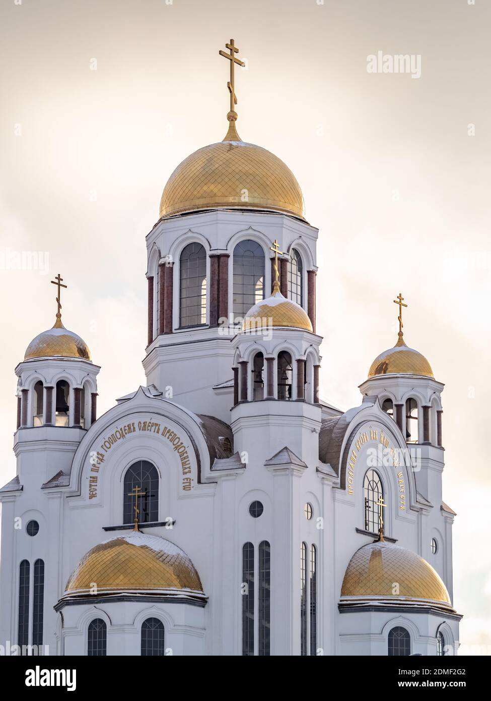 The golden domes of the Christian church are covered with snow in ...