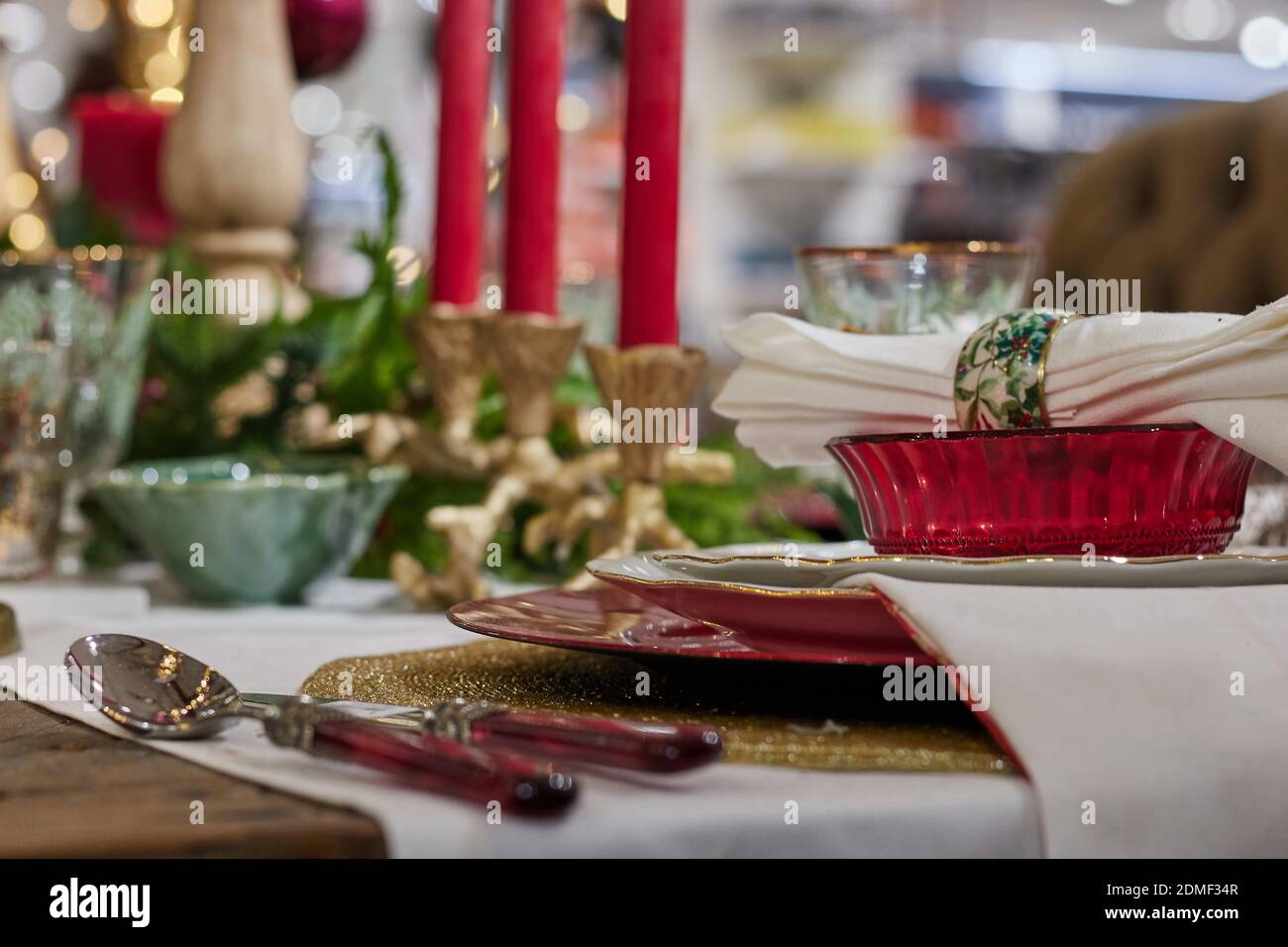 A closeup shot of decorative Christmas dinner set up within a table ...