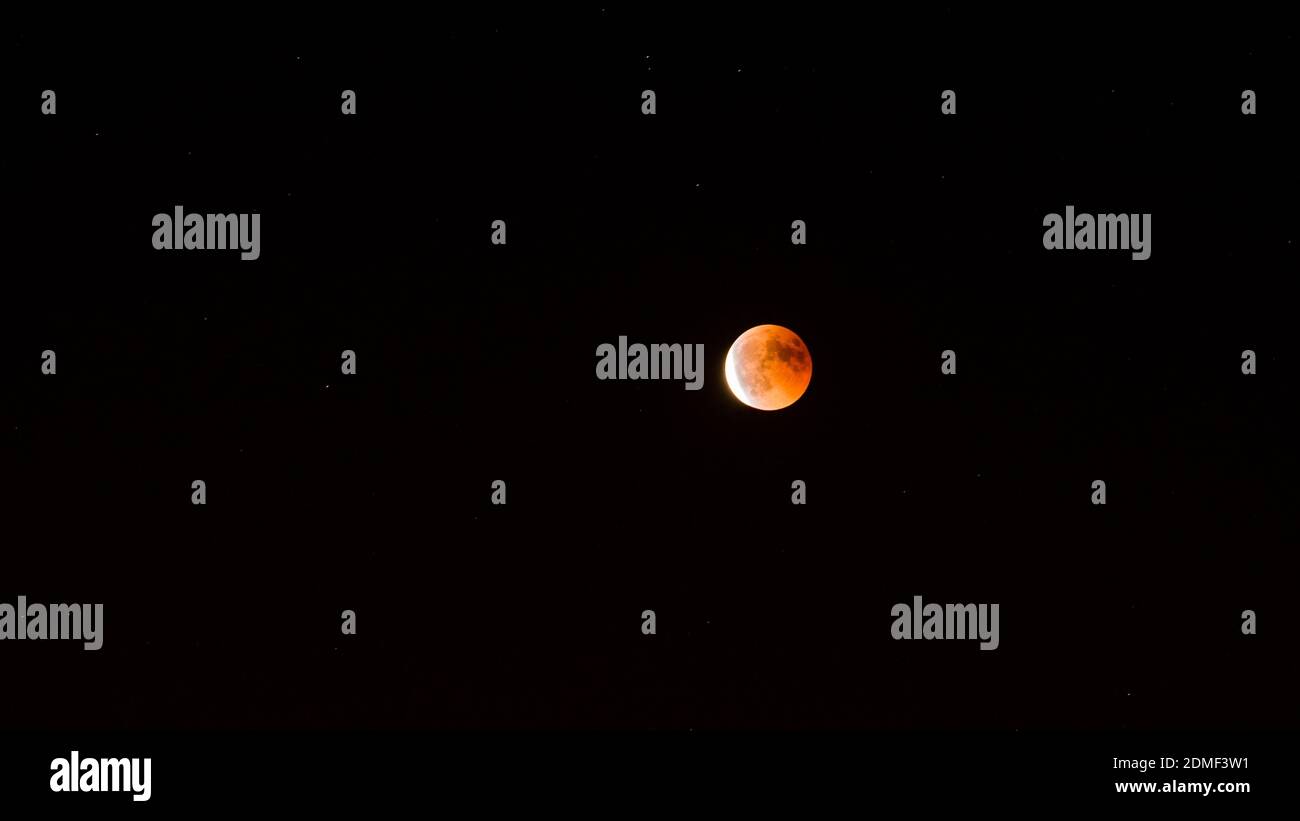 The half-red full moon against a dark background at night - great for ...