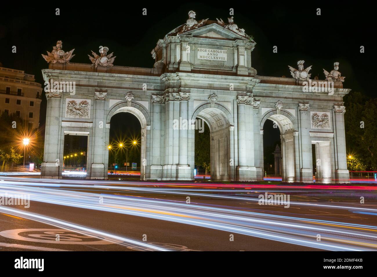 The Alcala Gate surrounded by lights with long exposure at night in ...