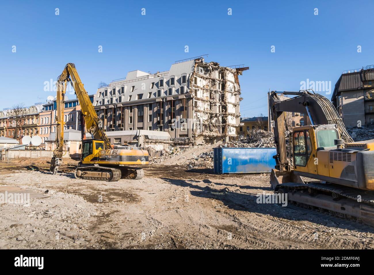 Construction machines near multi-storey building without walls and bare ...