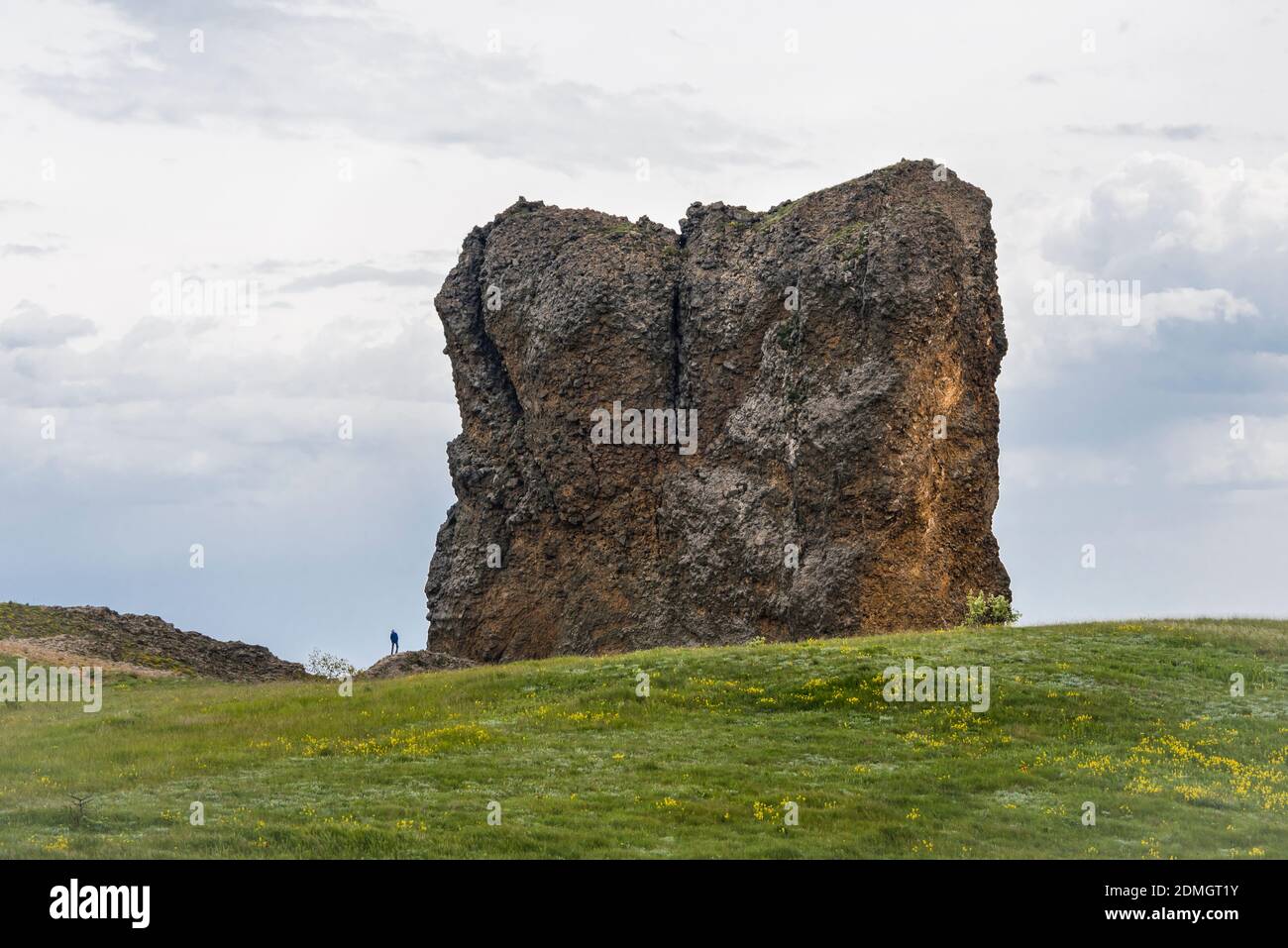 A huge rock of cubic shape on a green mountain valley Stock Photo - Alamy