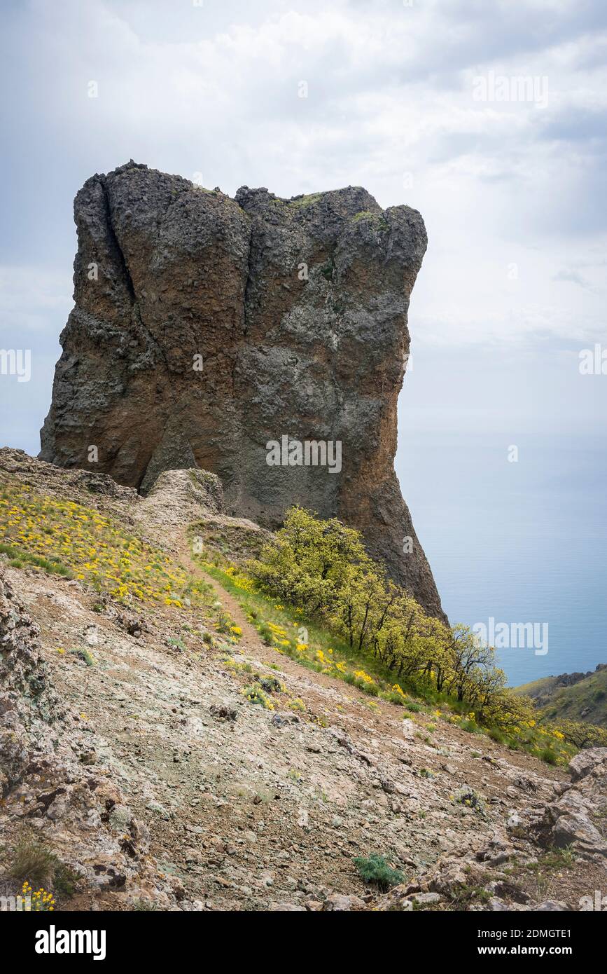 A huge rock of cubic shape on a green mountain valley Stock Photo - Alamy