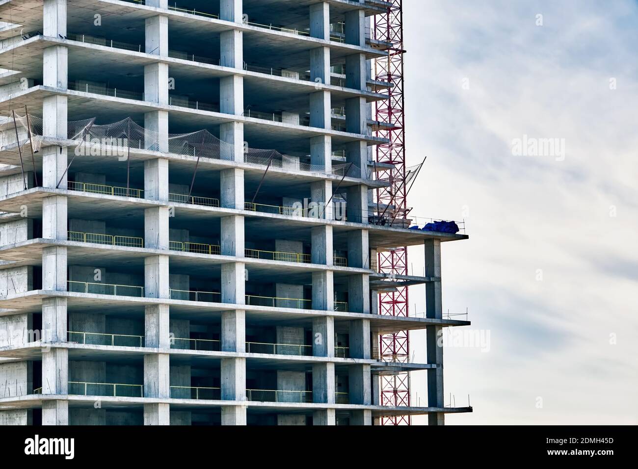 Skyscraper building under construction with safety net protective grid ...