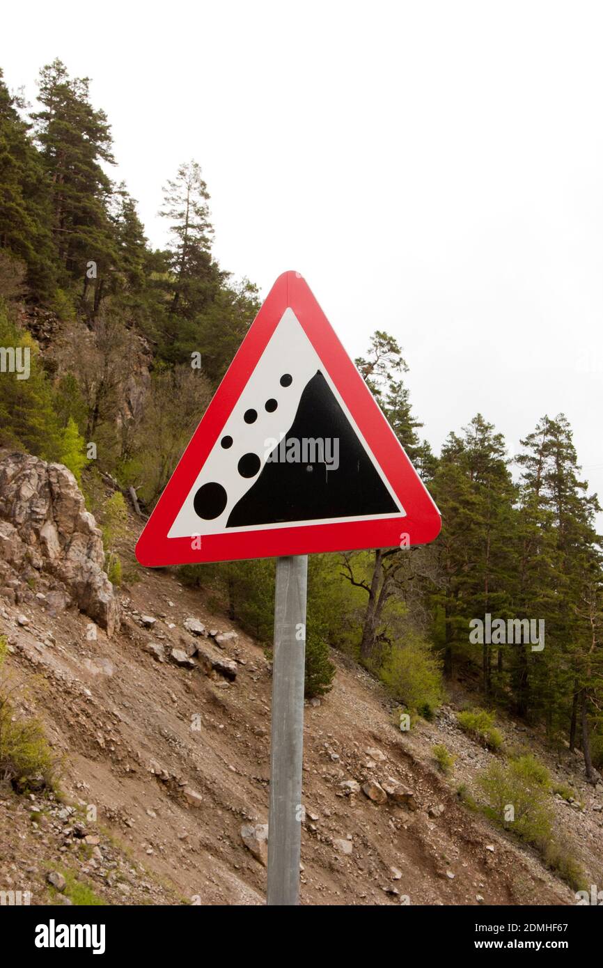 Road sign - Falling rocks. Road sign "Falling rocks" on the background ...