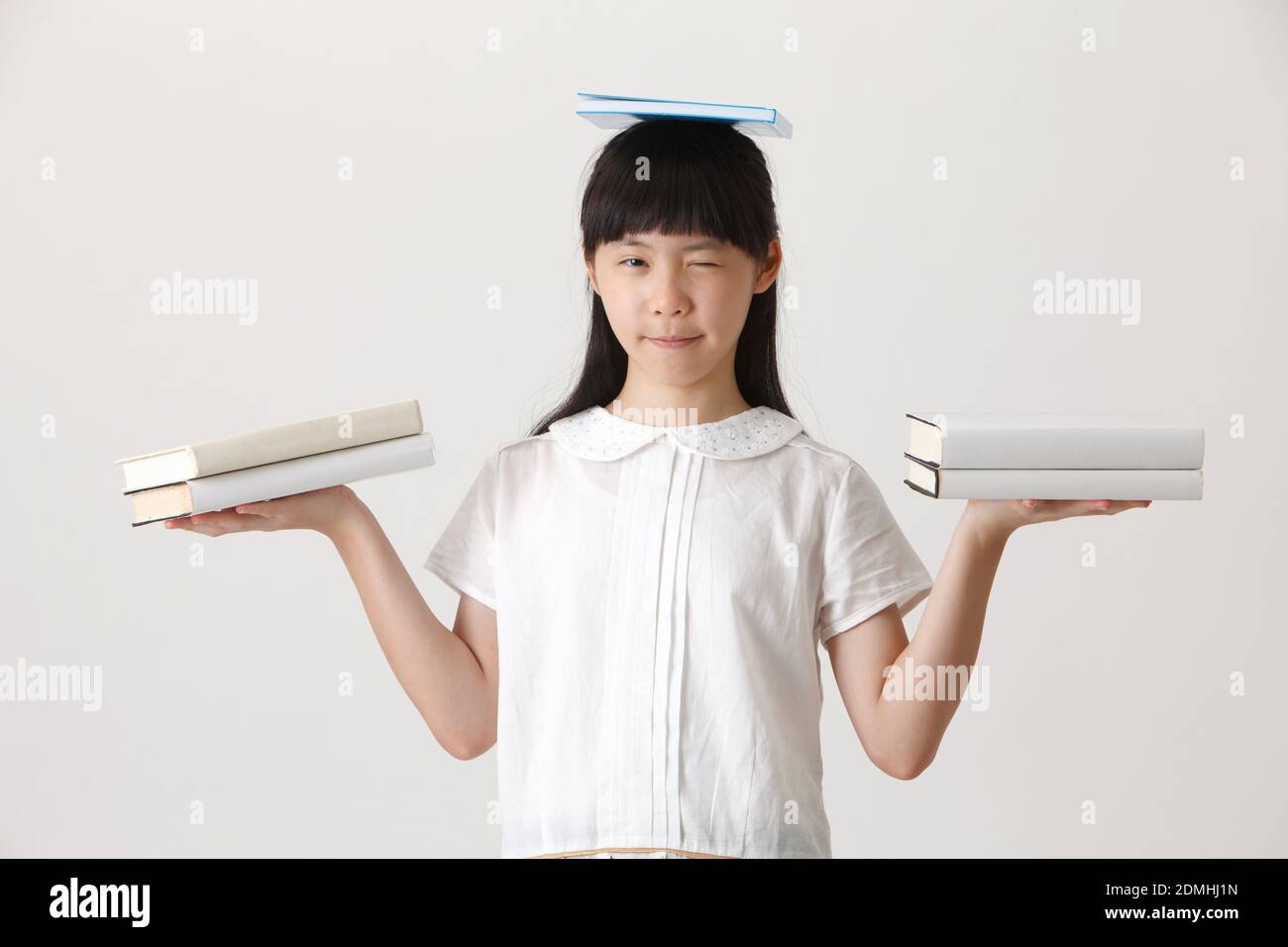 Woman balancing books head hi-res stock photography and images - Alamy