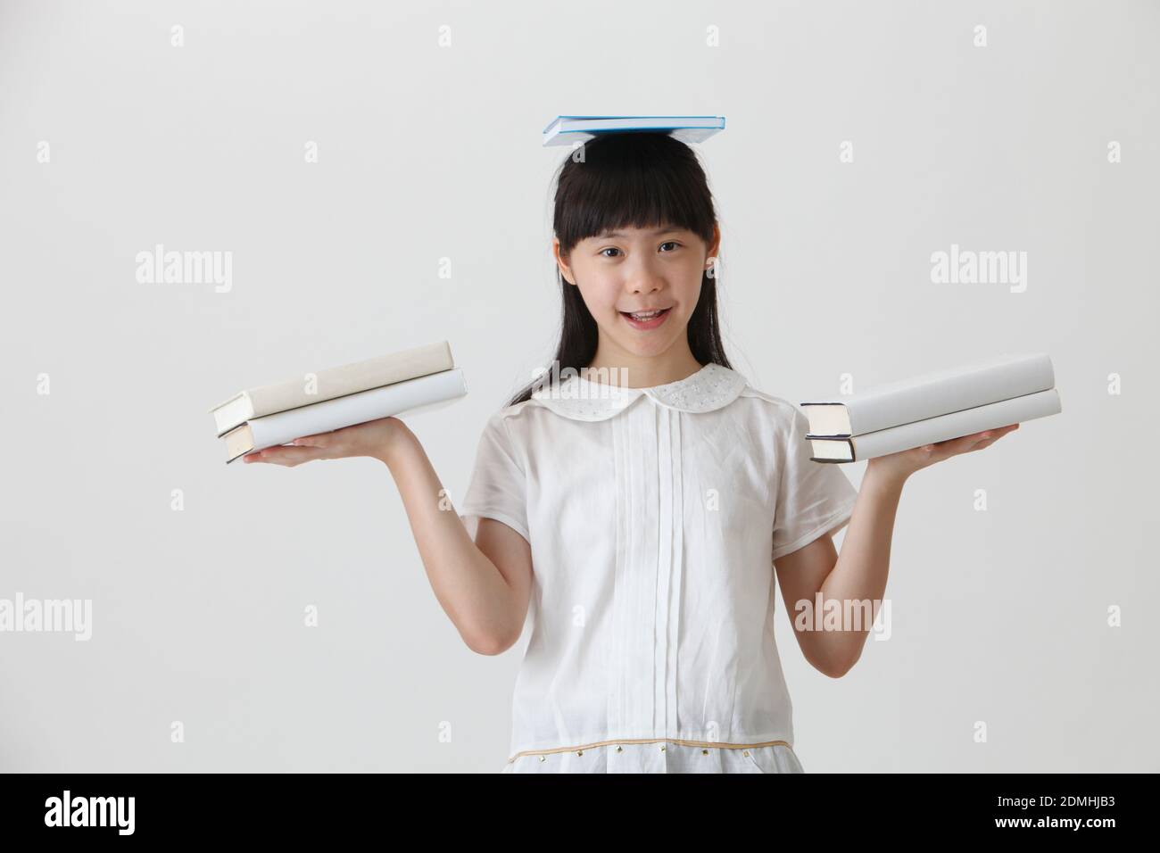 Balancing books on head hi-res stock photography and images - Alamy