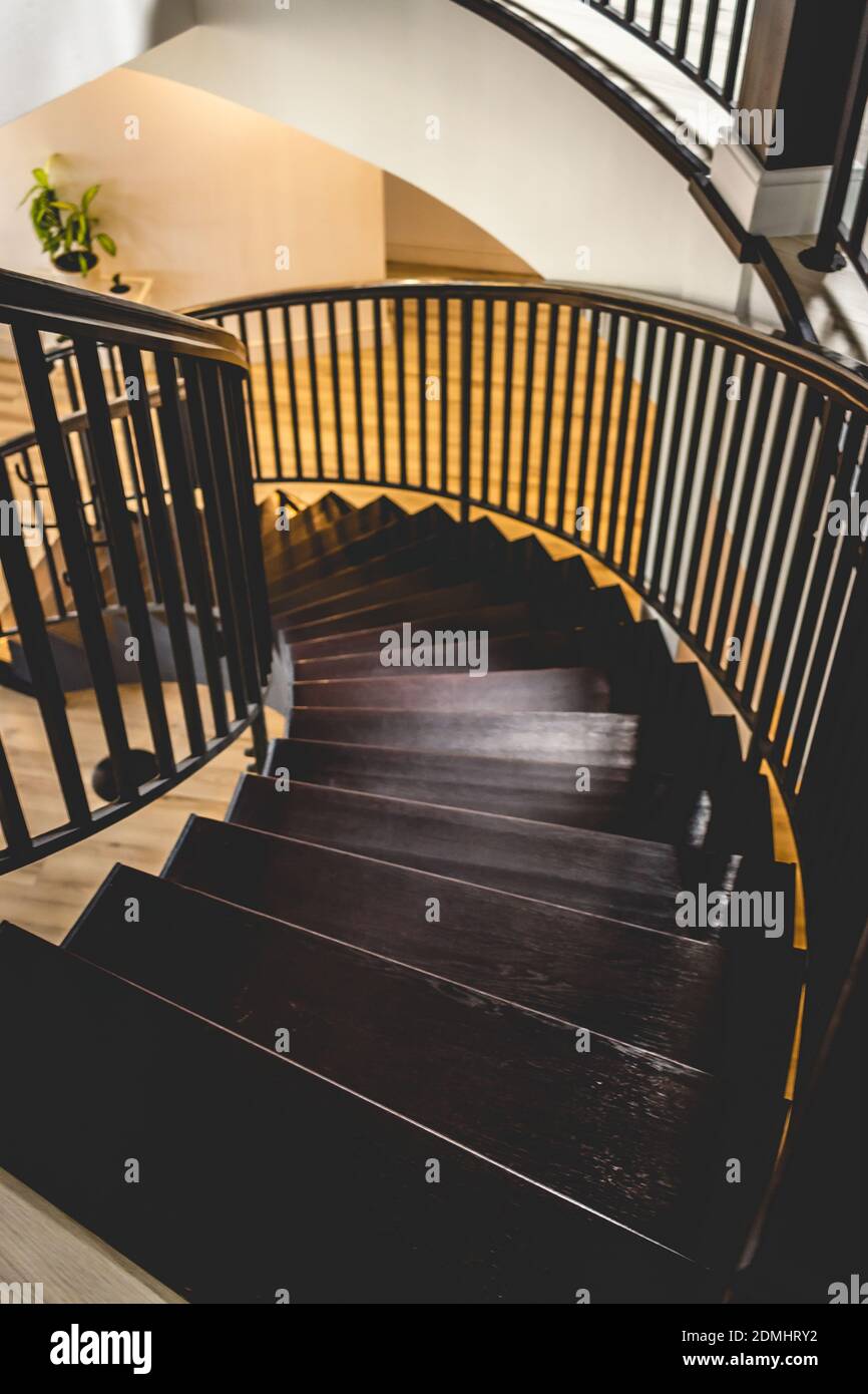A vertical shot of an elegant turning staircase Stock Photo - Alamy