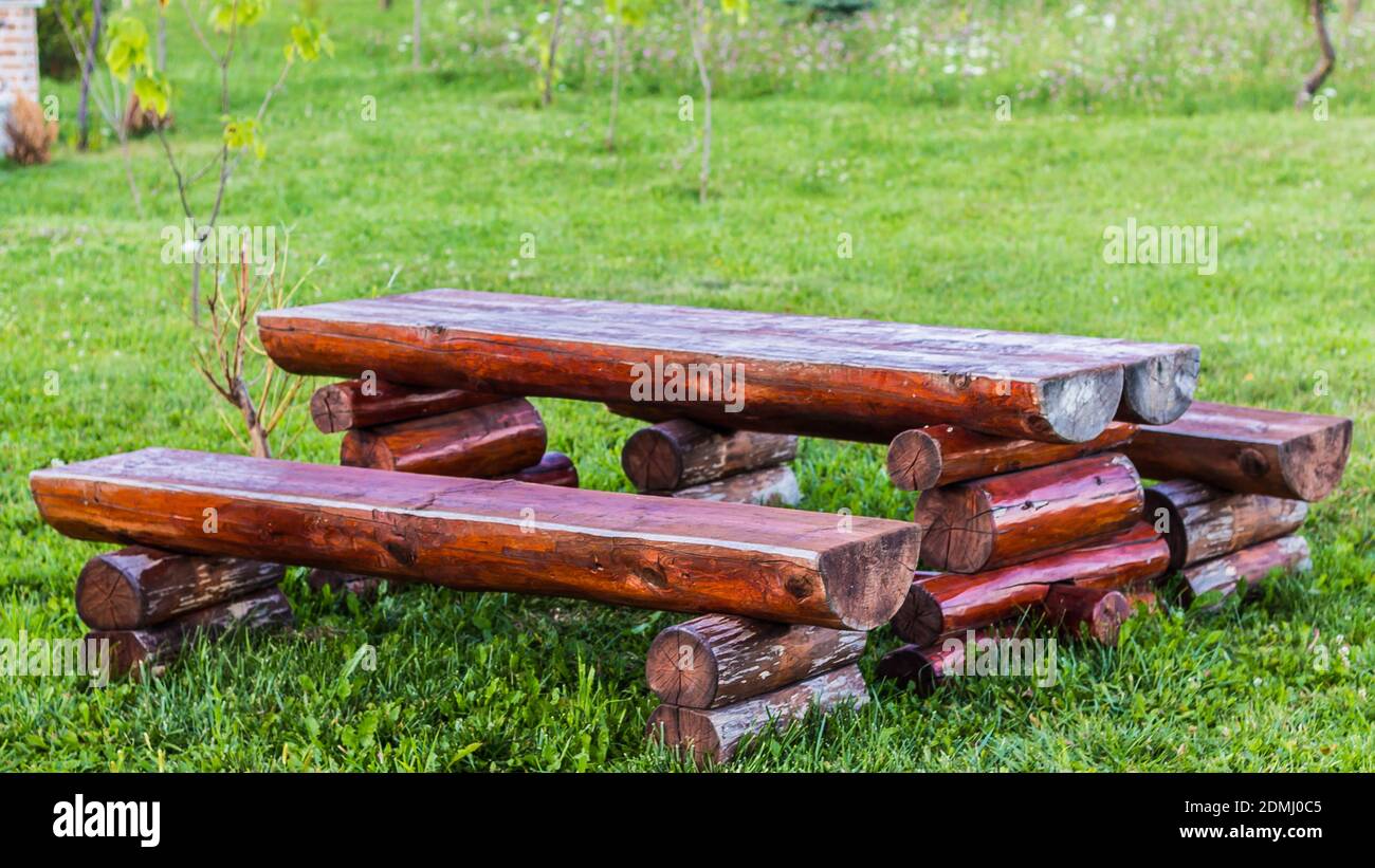 A wooden picnic table with chairs at a park Stock Photo - Alamy
