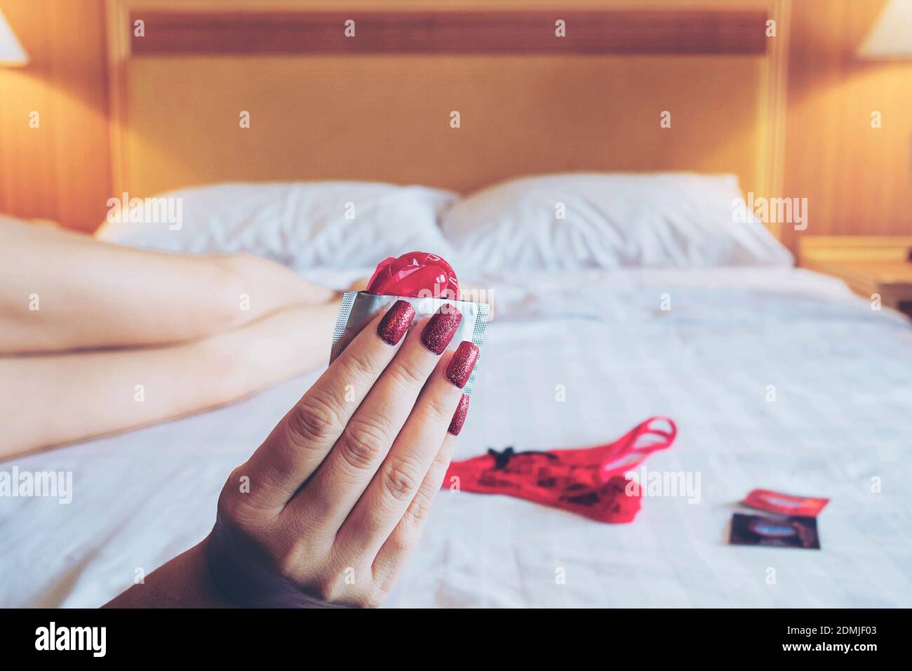 Woman holding condom hi-res stock photography and images - Alamy