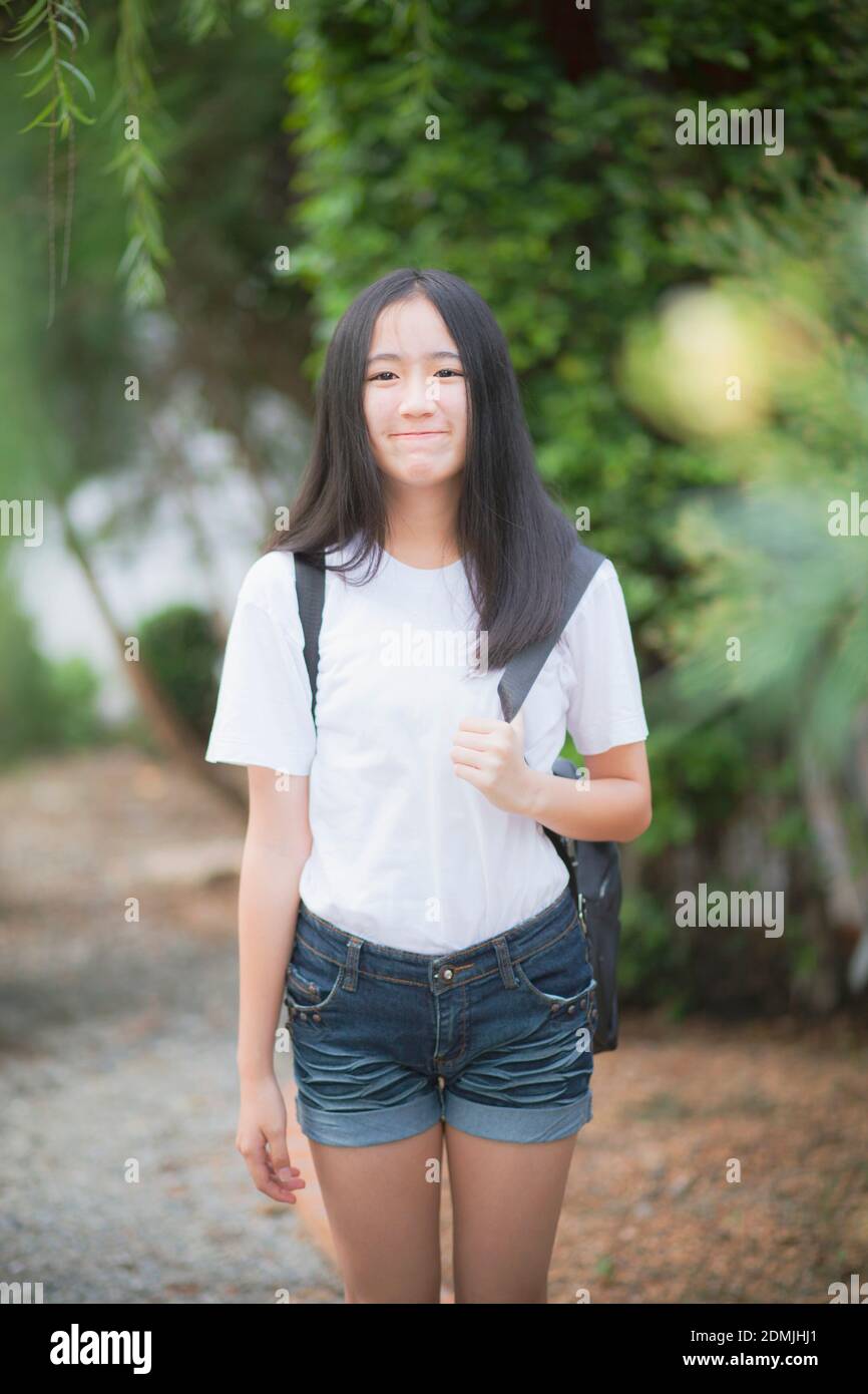 Portrait Of Teenage Girl Standing Against Trees Stock Photo - Alamy