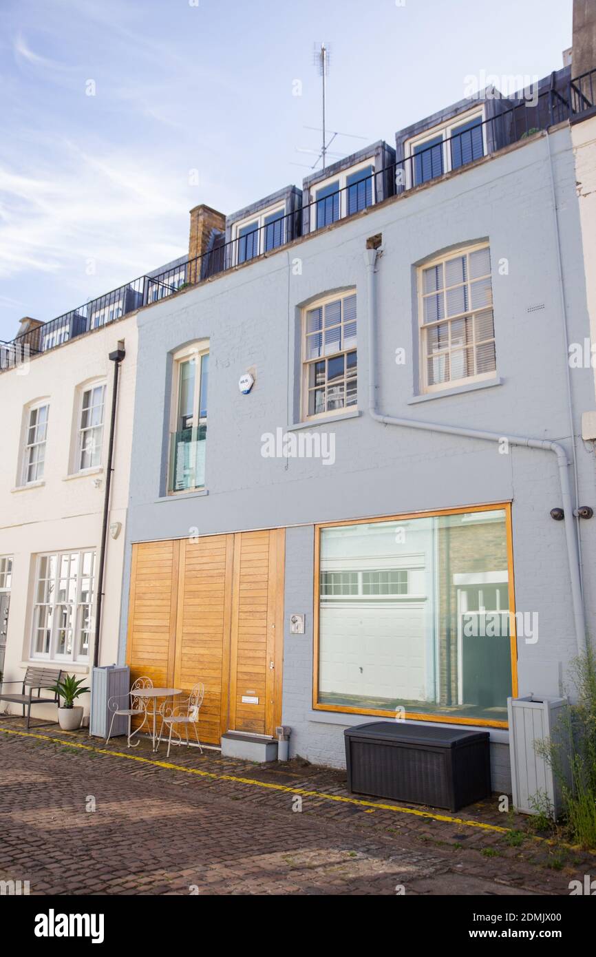 Colorful British house with a big square window and wooden door Stock ...