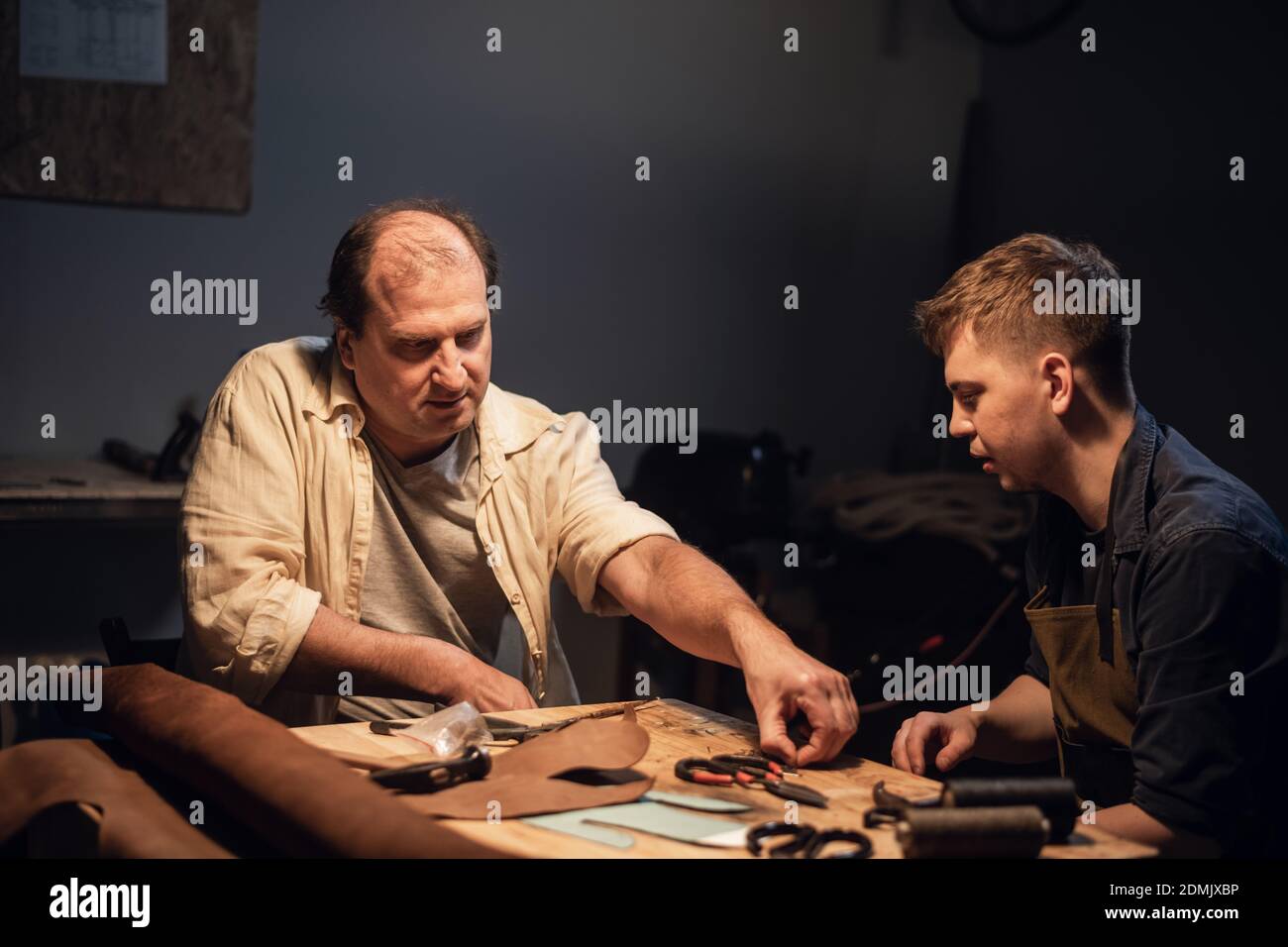 father-shoemaker prepares a successor in the family business of manual ...