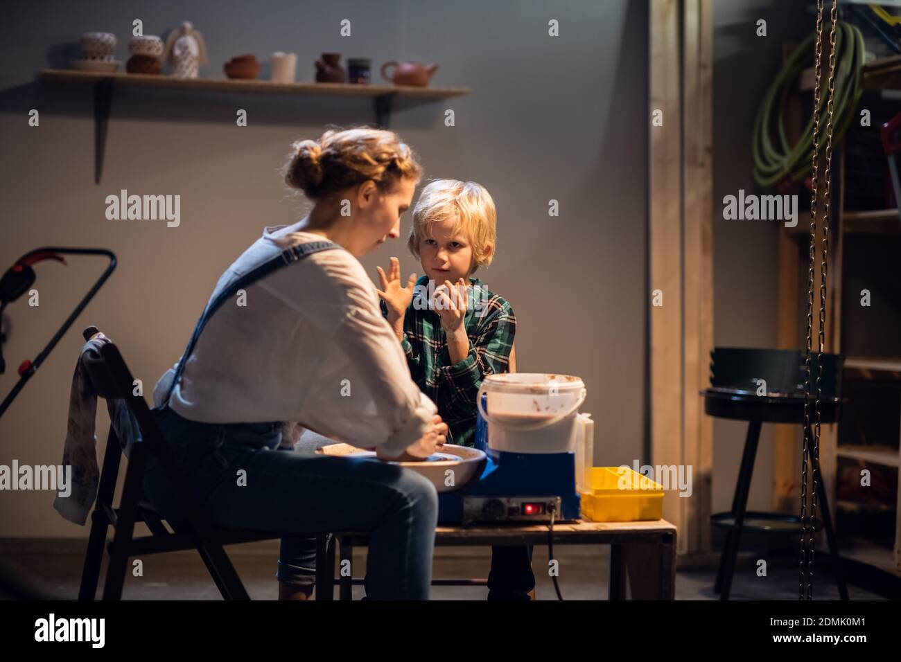 the older sister and her younger brother spend time in a pottery ...
