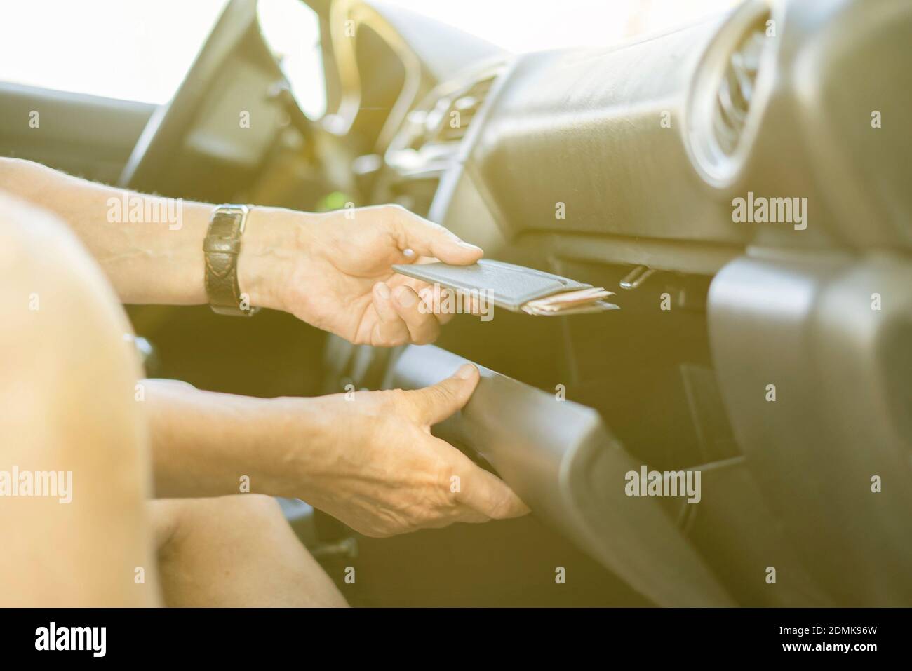 person's hand take wallet cash and credit card from the glove ...