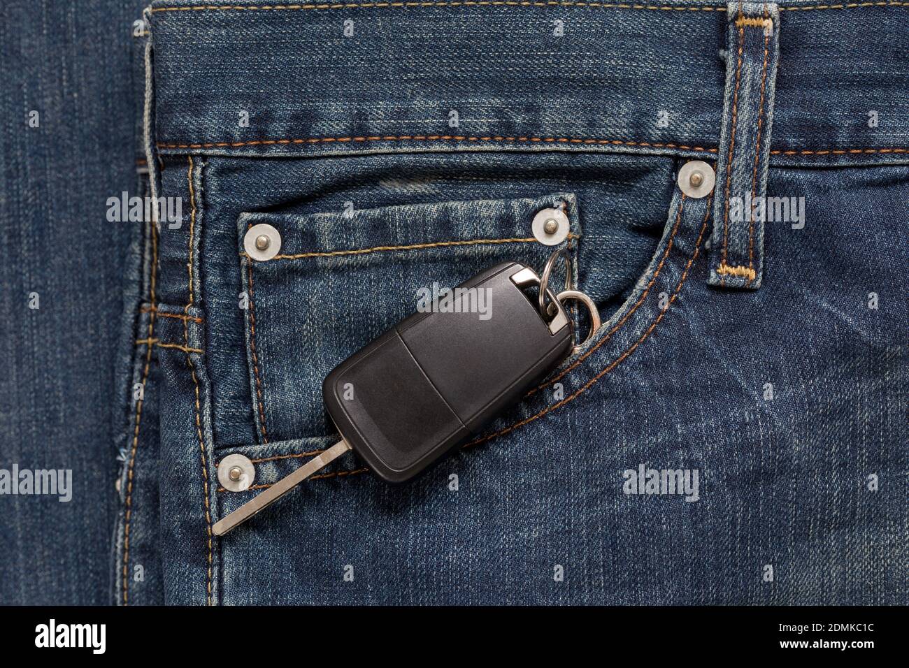 Ignition key is lying in side pocket of blue jeans. Modern lifestyle ...